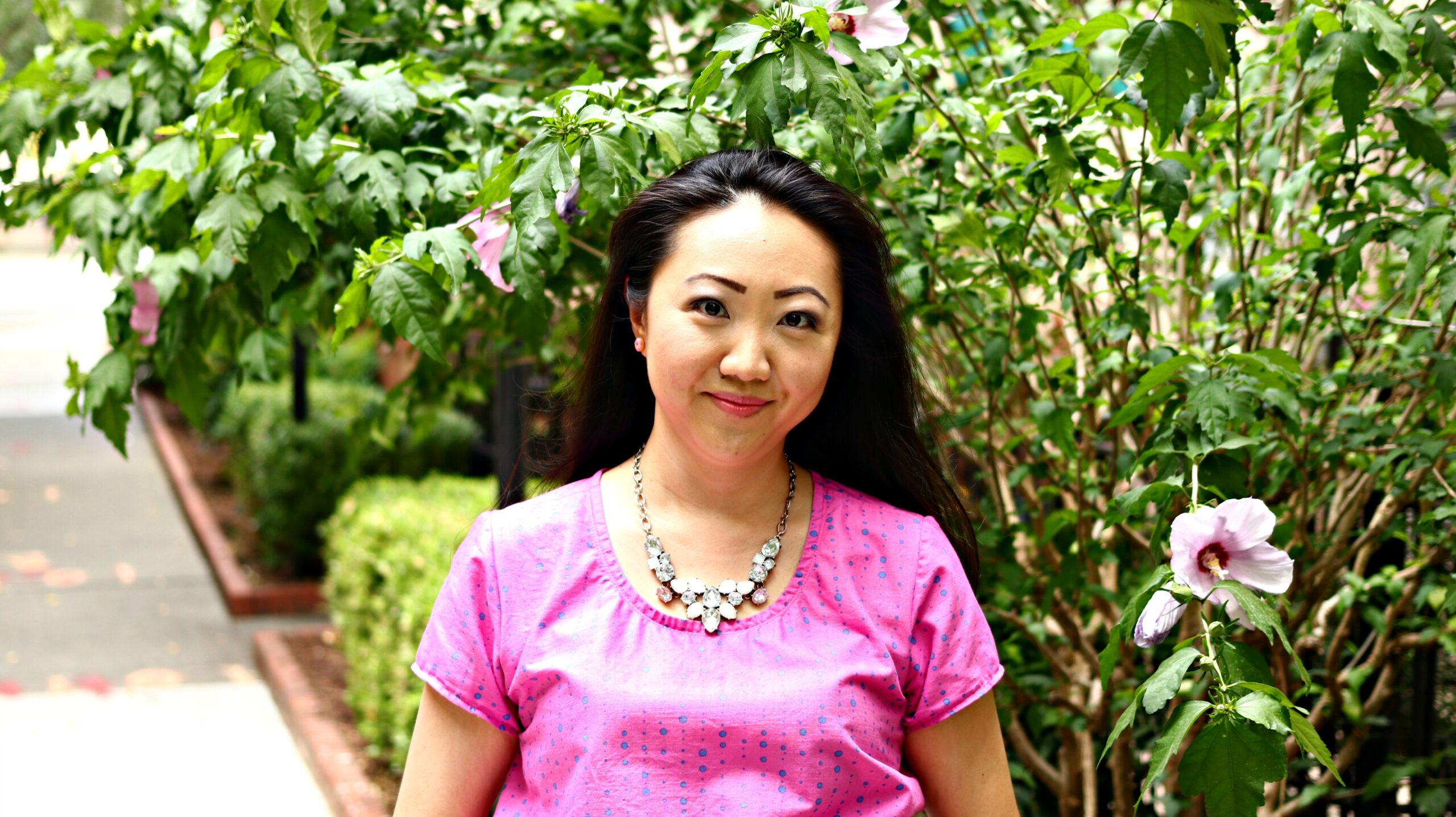 Jennifer Pink Outfit Mid Shot Flower Background Smiling EDITED – Sewing ...